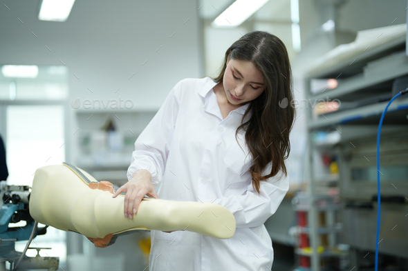 Orthopedic technician making prosthetic leg for disabilities people in workshop. Stock Photo by ...